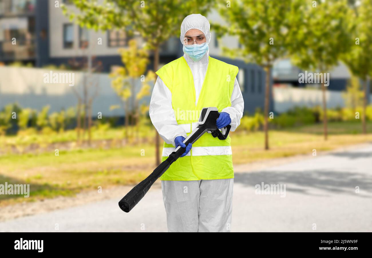 sanitation worker in hazmat with pressure washer Stock Photo - Alamy