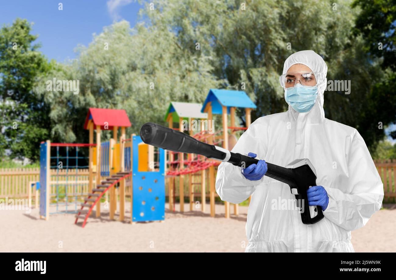 sanitation worker in hazmat with pressure washer Stock Photo - Alamy
