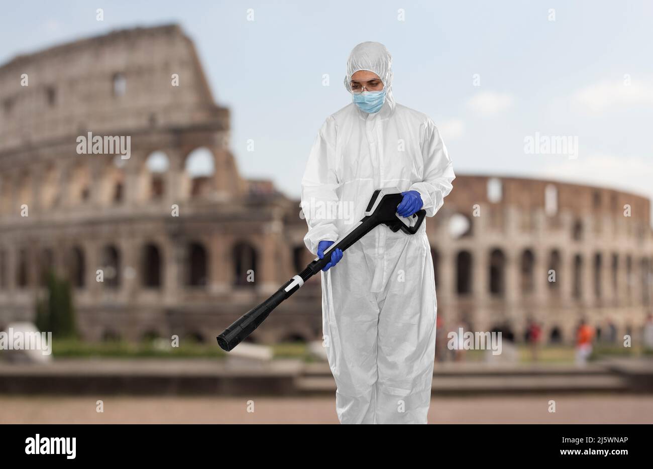 sanitation worker in hazmat with pressure washer Stock Photo - Alamy
