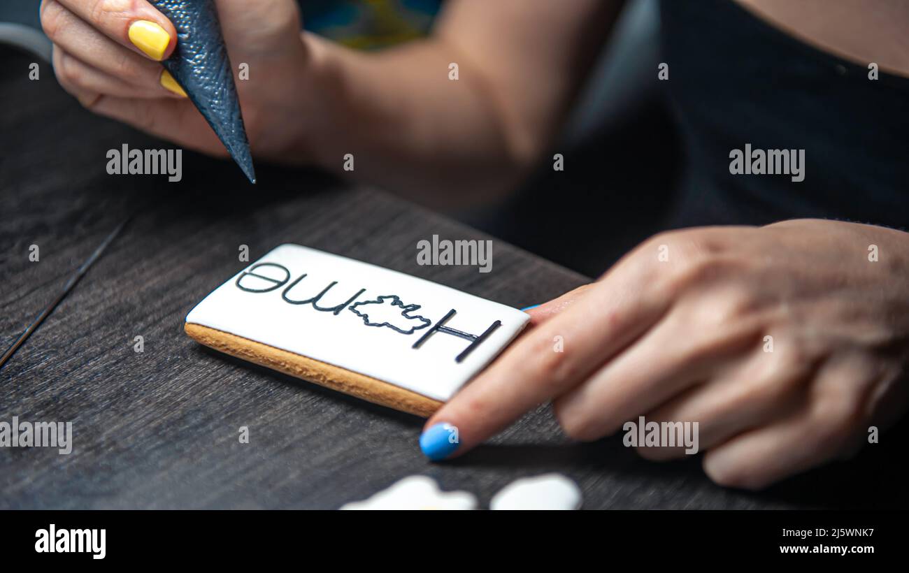 A woman makes patriotic gingerbread in support of Ukraine Stock Photo ...