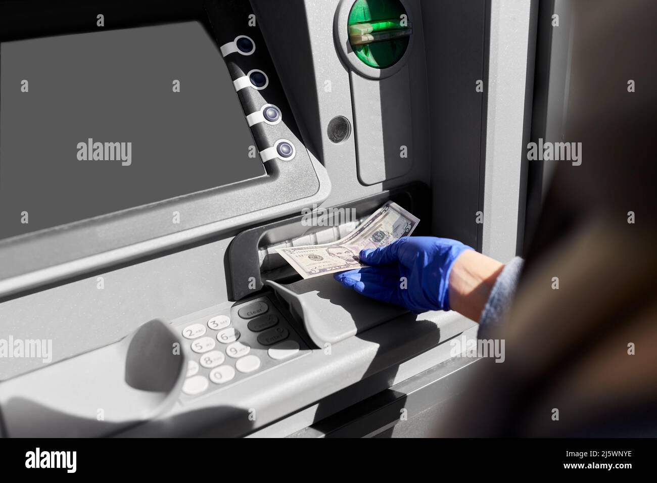 hand in medical glove with money at atm machine Stock Photo - Alamy