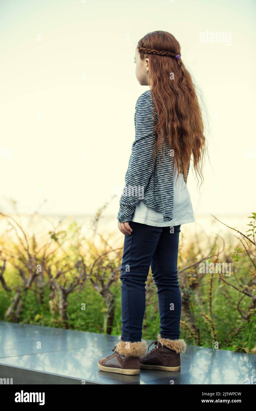 Rear view of redhead girl standing outdoors Stock Photo - Alamy