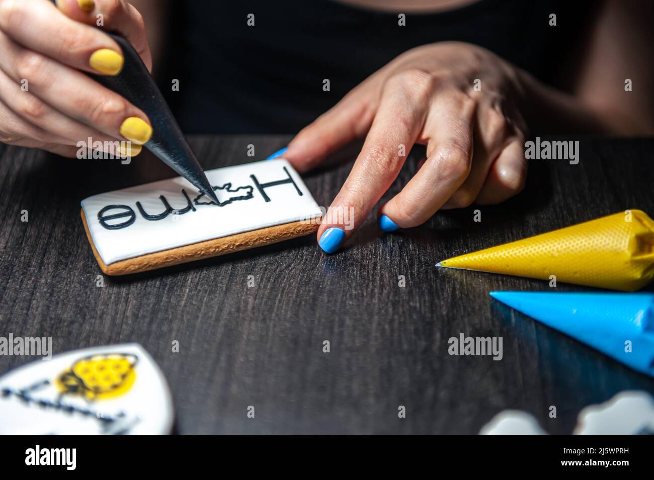 A woman makes patriotic gingerbread in support of Ukraine Stock Photo ...