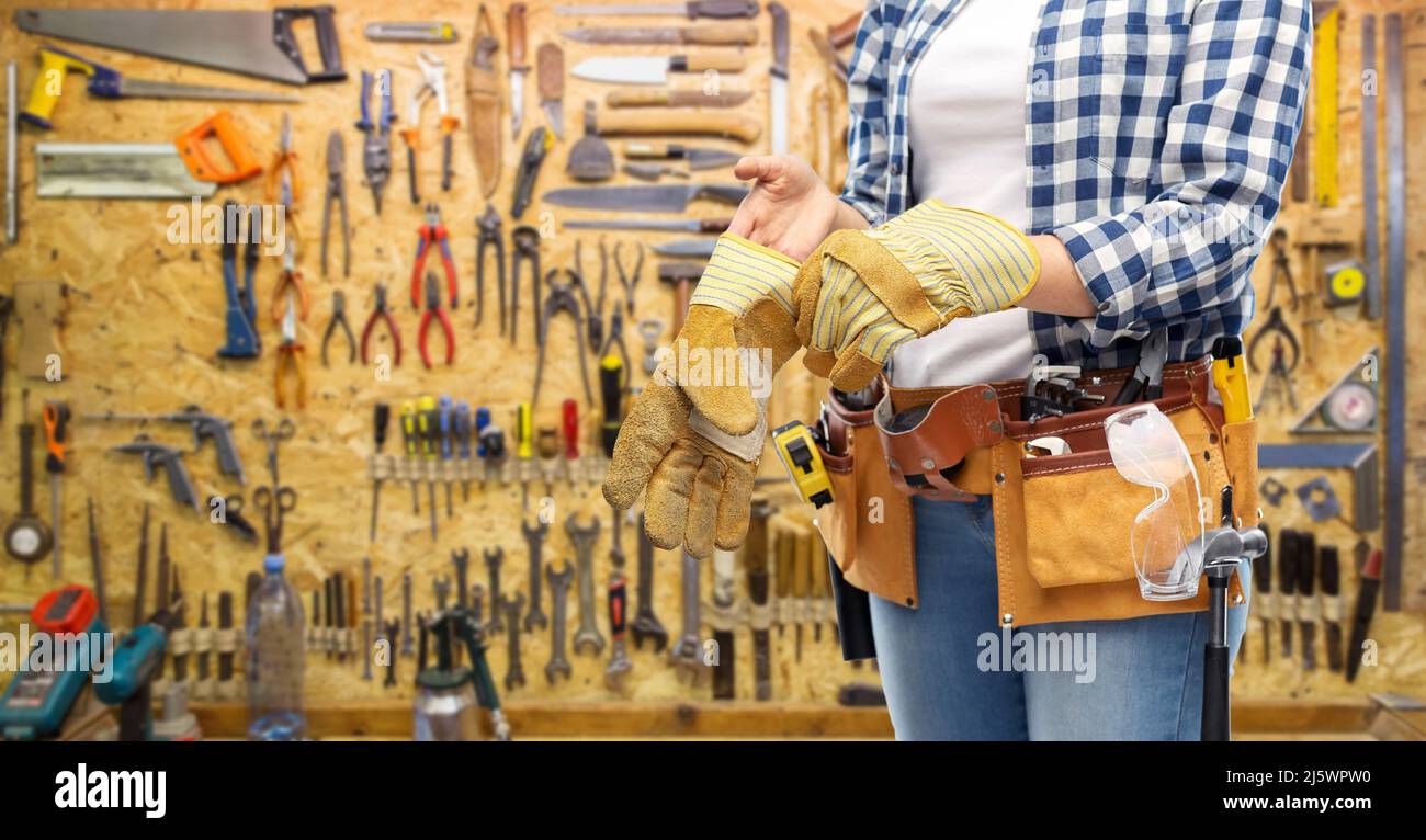 woman or builder with gloves and working tools Stock Photo - Alamy