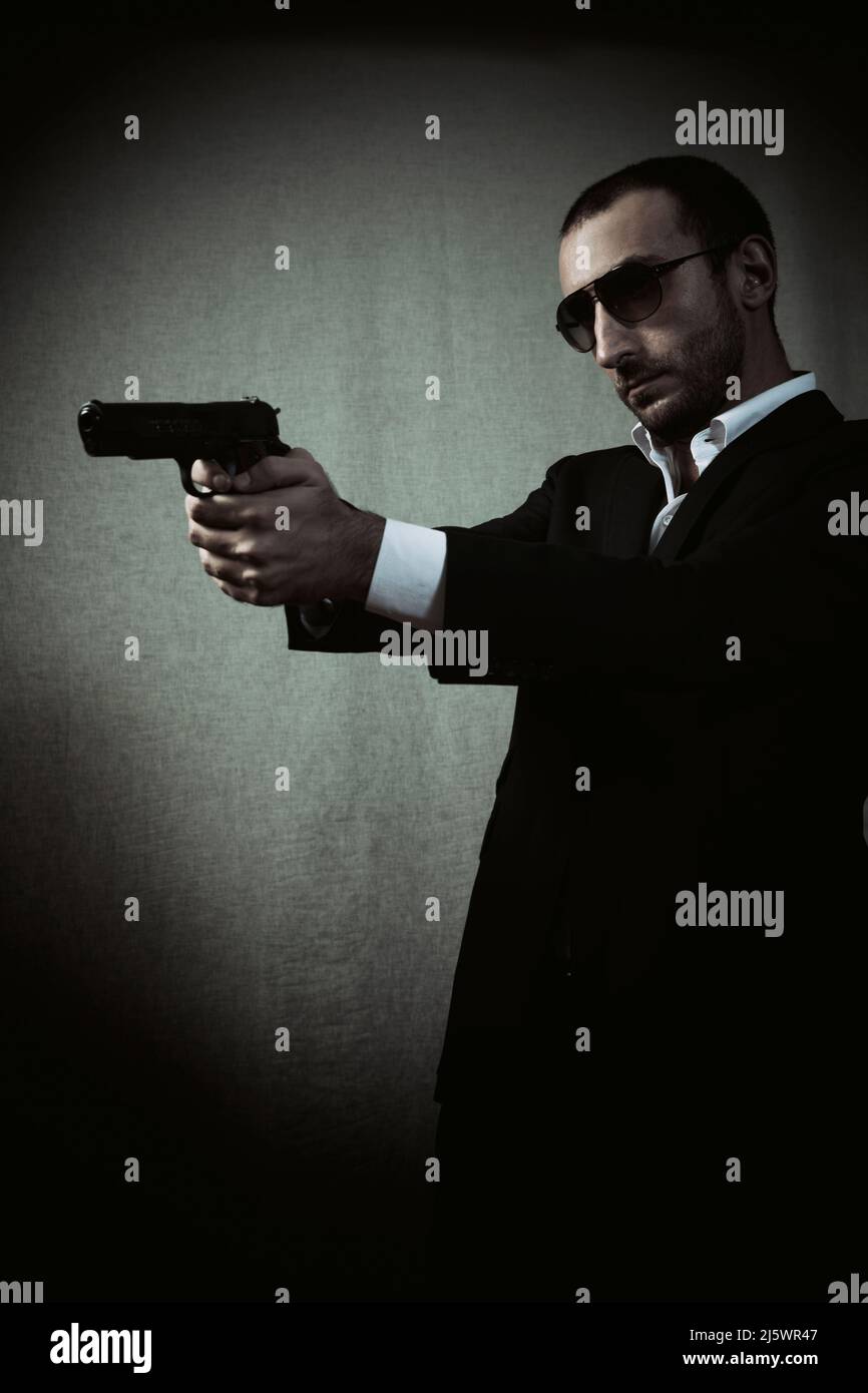 Special agent holding a gun Stock Photo - Alamy
