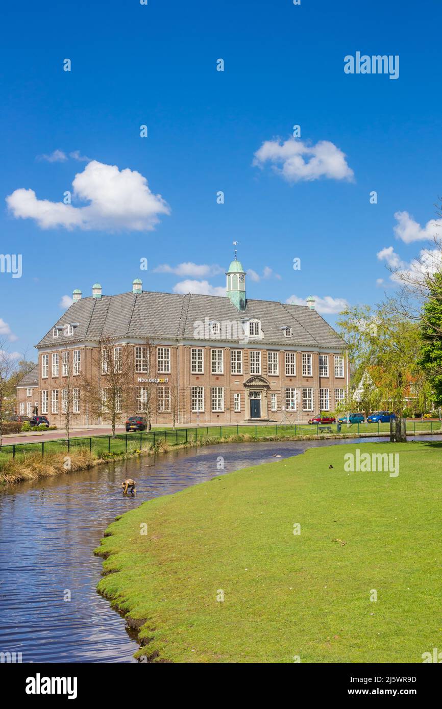 Pond in front of the historic school building of Veendam, Netherlands ...