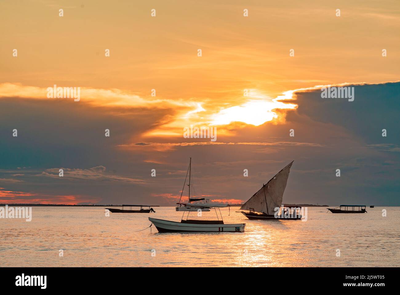 Fishing ship and boats in water of Indian ocean on a scenic sunset ...