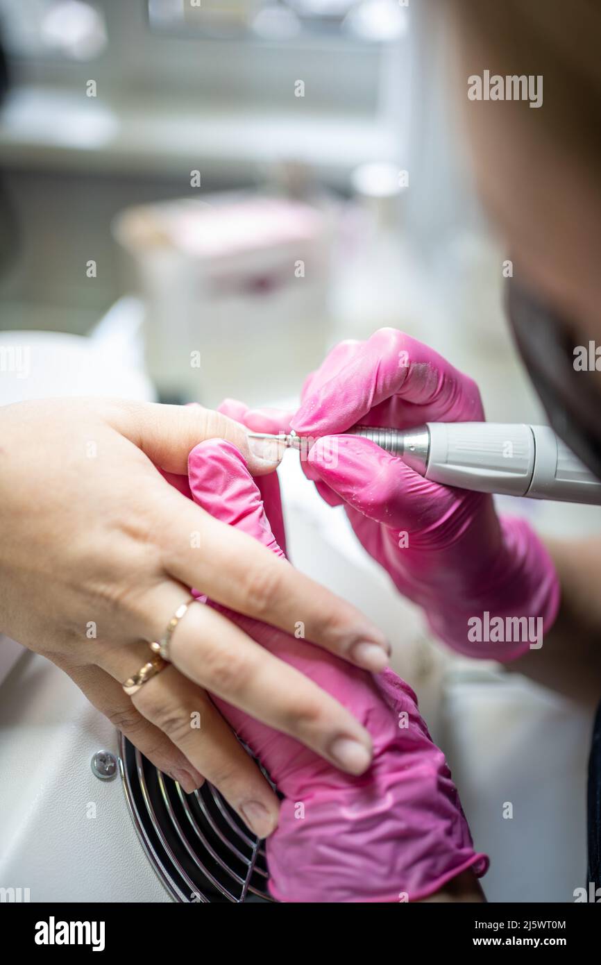 Manicure artist making professional manicure in beauty salon Stock ...