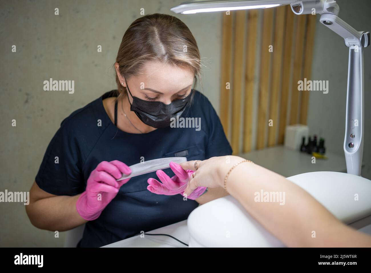 Manicure artist making professional manicure in beauty salon Stock ...