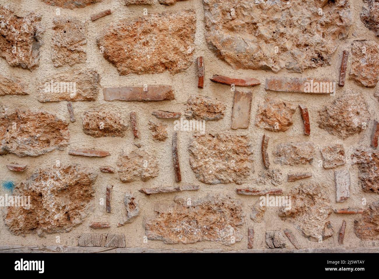 Antique masonry from blocks of different sizes in cement mortar Stock ...