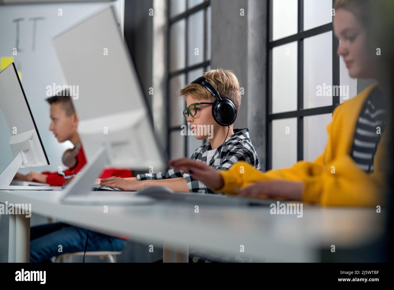 School kids using computer in classroom at school Stock Photo - Alamy