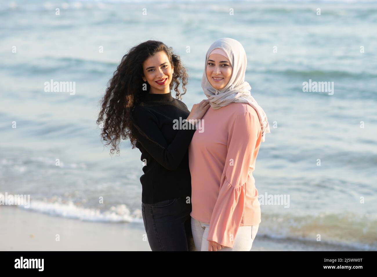 Muslim sisters on the beach Stock Photo - Alamy