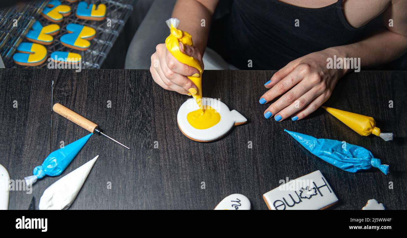 Preparation of handmade gingerbread with symbols of Ukraine, icing ...