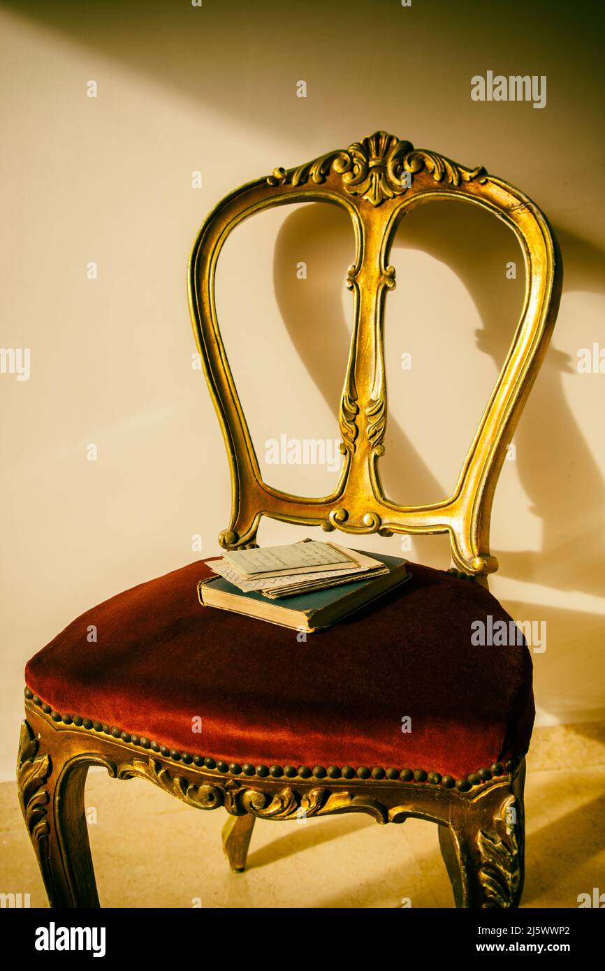 Book and old letters over a red chair Stock Photo - Alamy