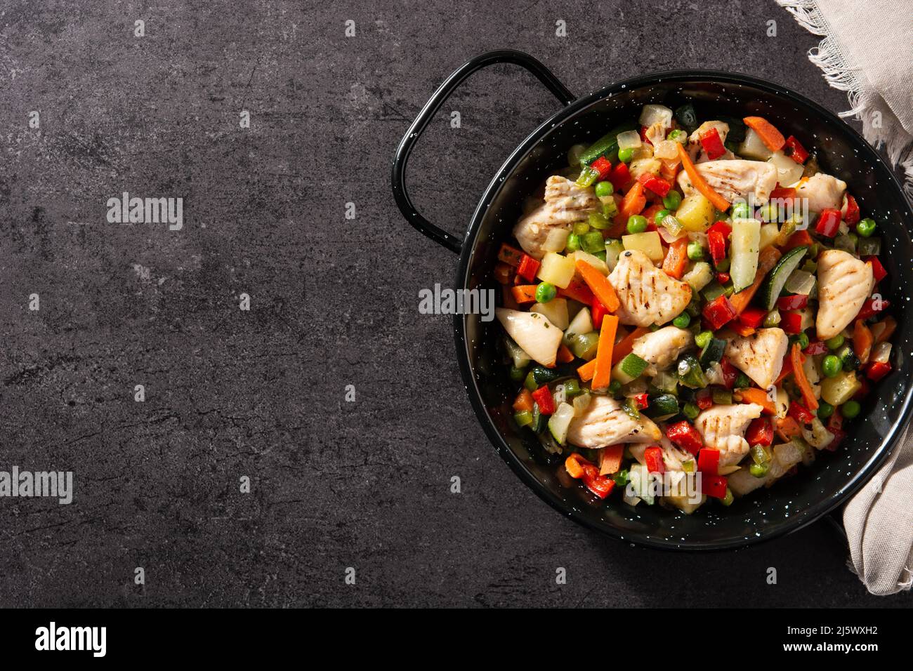 Chicken stir fry and vegetables on black stone background Stock Photo ...