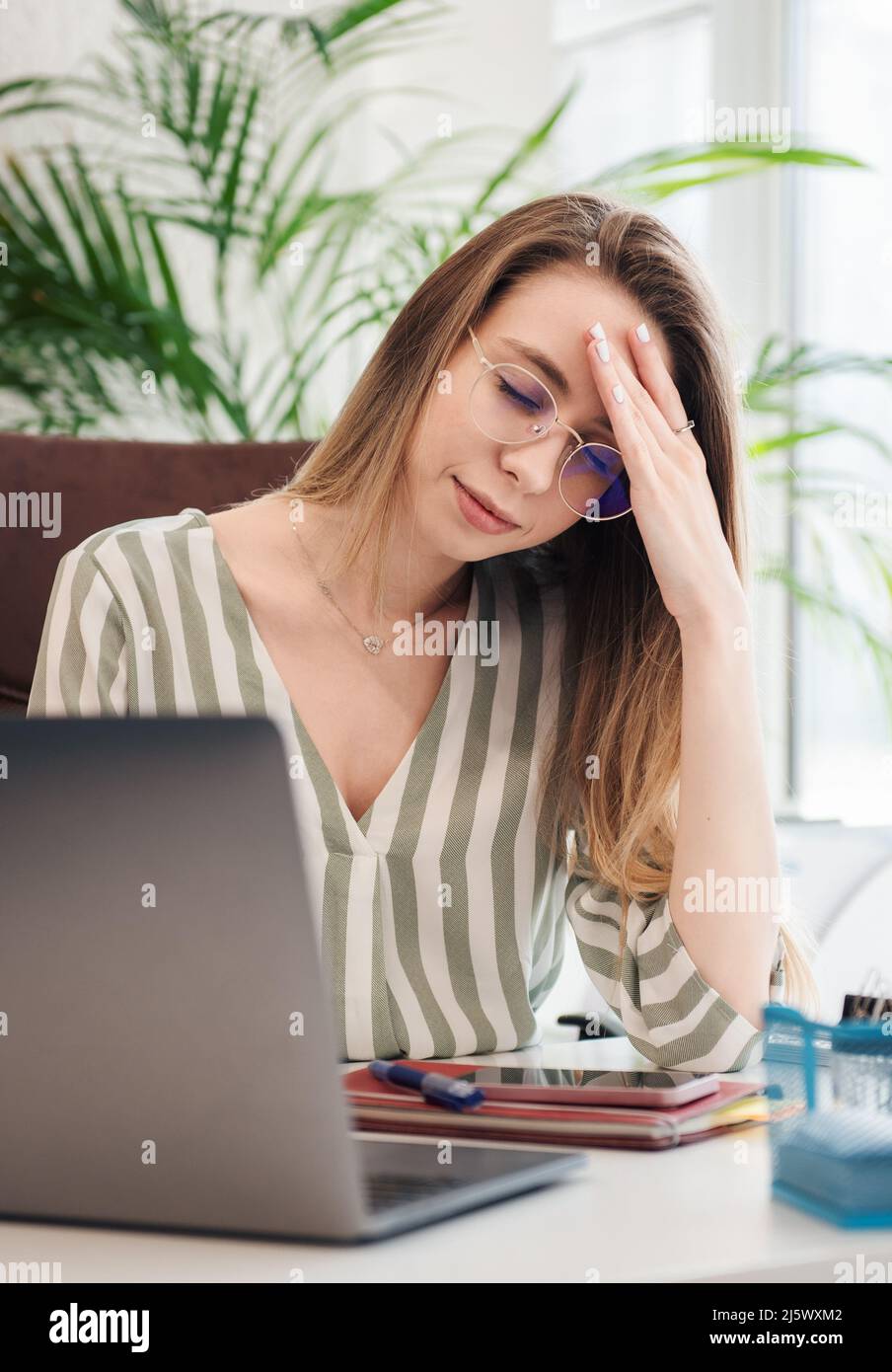 Young woman working on a computer in her office Stock Photo - Alamy