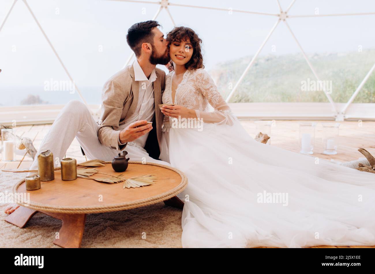 Tea ceremony at a boho wedding. Bride and groom in boho Stock Photo - Alamy