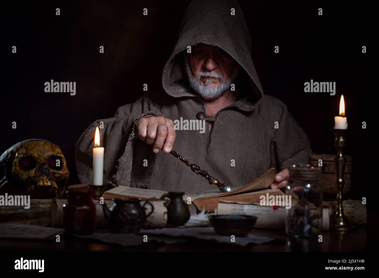 Merlin with his spell book and wand Stock Photo - Alamy