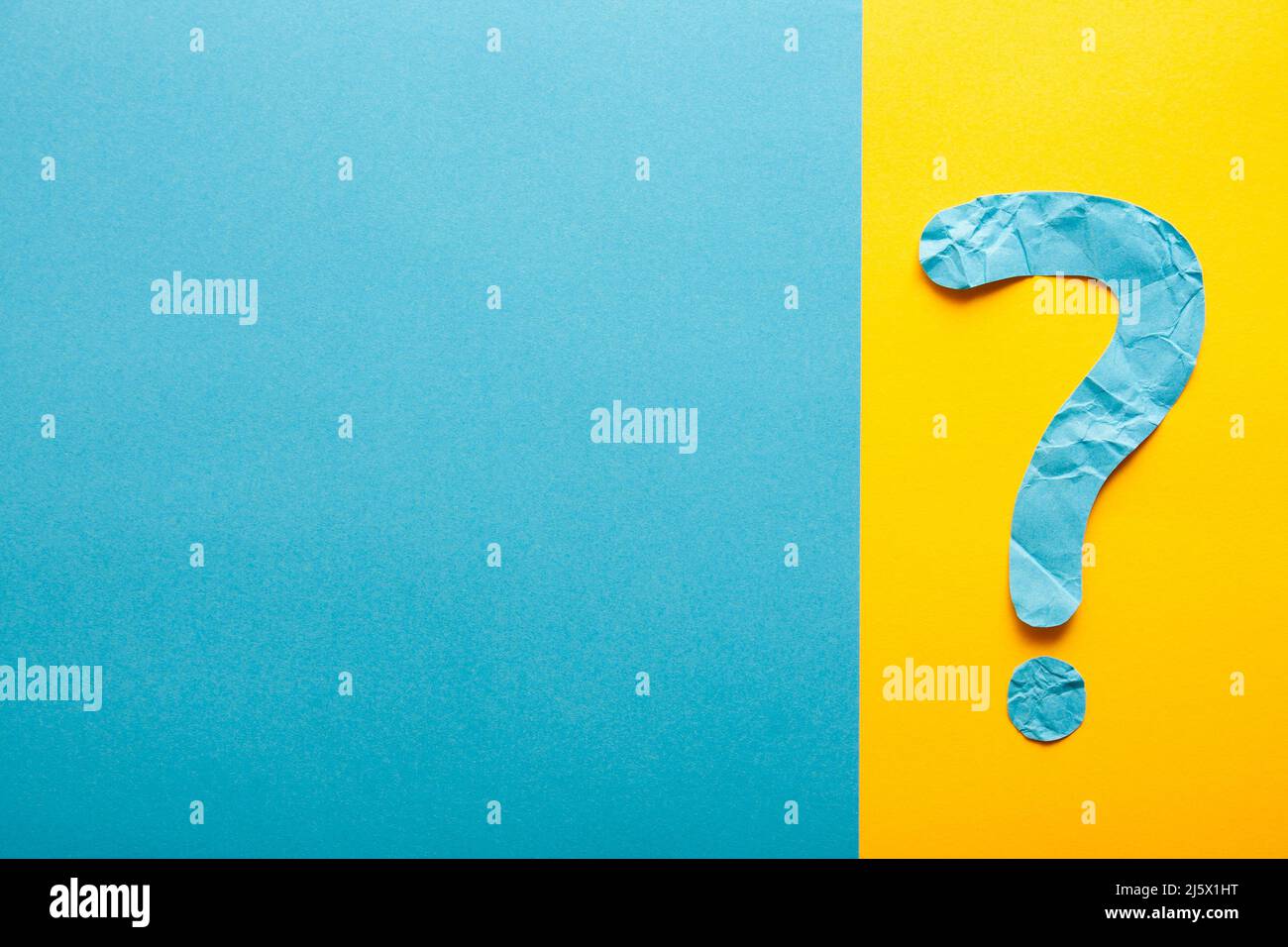 Blue crumpled paper question mark on yellow background Stock Photo - Alamy