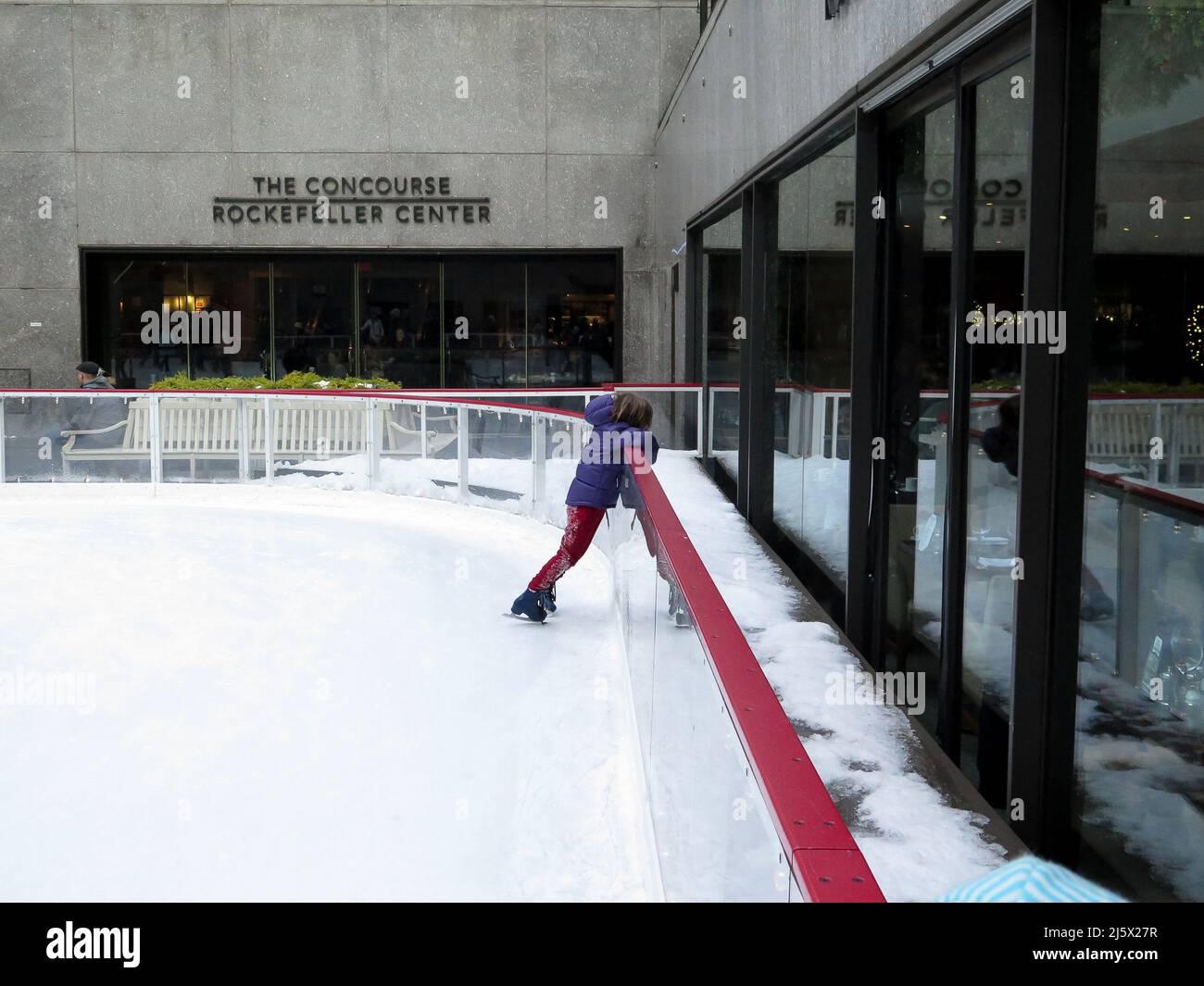 young child trying to ice skate at Rockerfeller centre, New York City ...