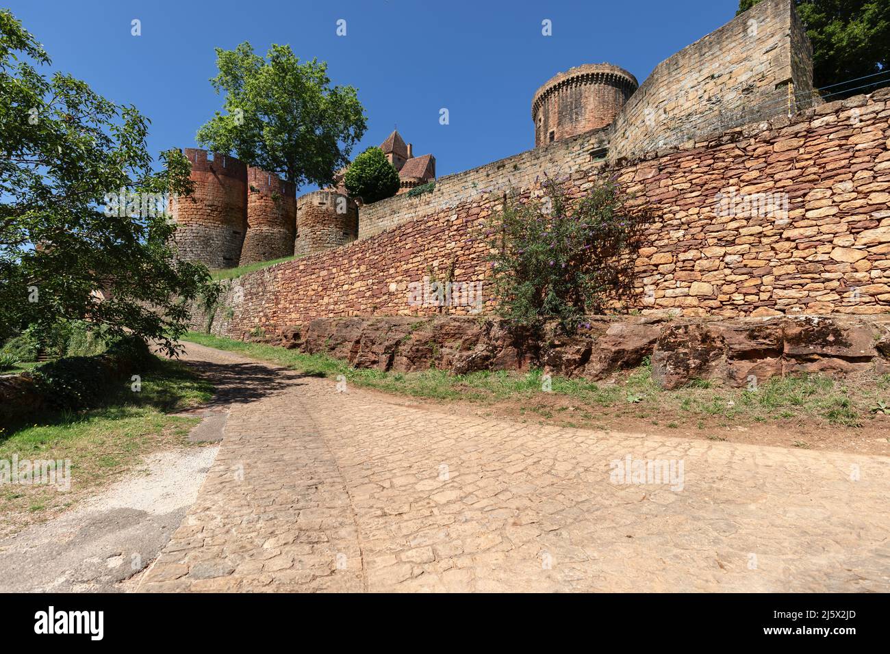 Eastern wall of red brick triangular fortified castle Chateau de ...