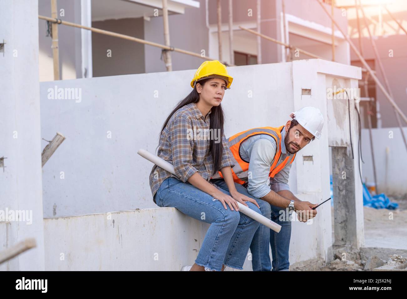 Engineer and architect are stressed at construction site,He is having ...