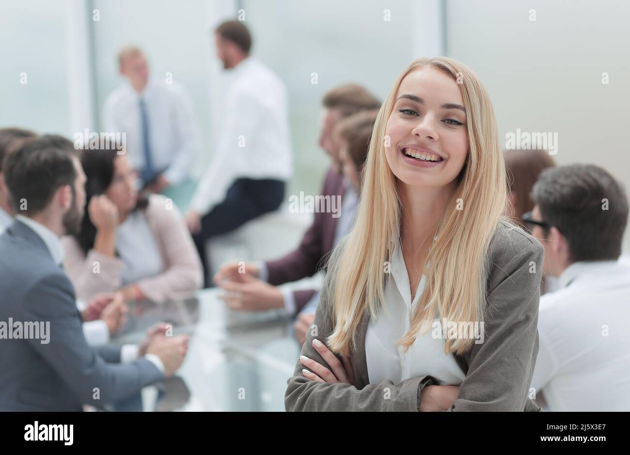 close up. smiling young employee standing in the office Stock Photo - Alamy