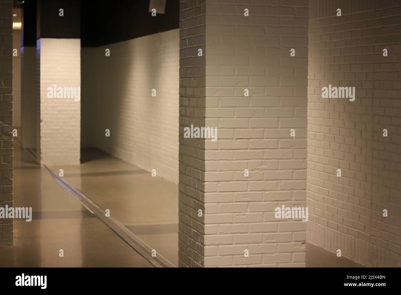 Unusual and interesting interior room with brick columns and a winding ...