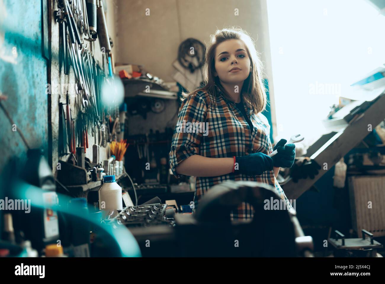 Female auto mechanic at auto service station, indoors. Gender equality ...