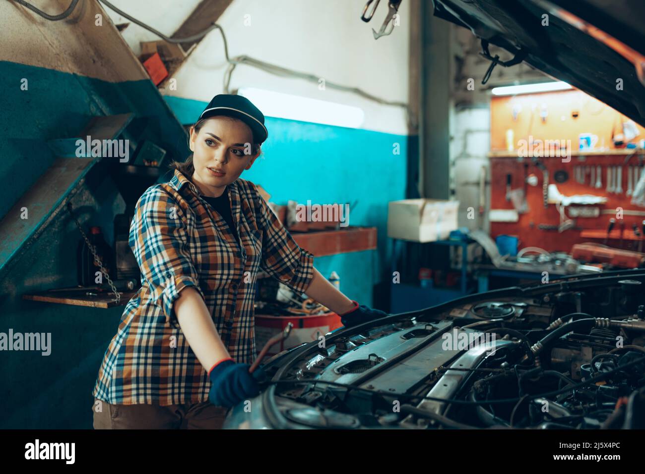Car reapir, exam. Young pretty girl, auto mechanic working at auto ...