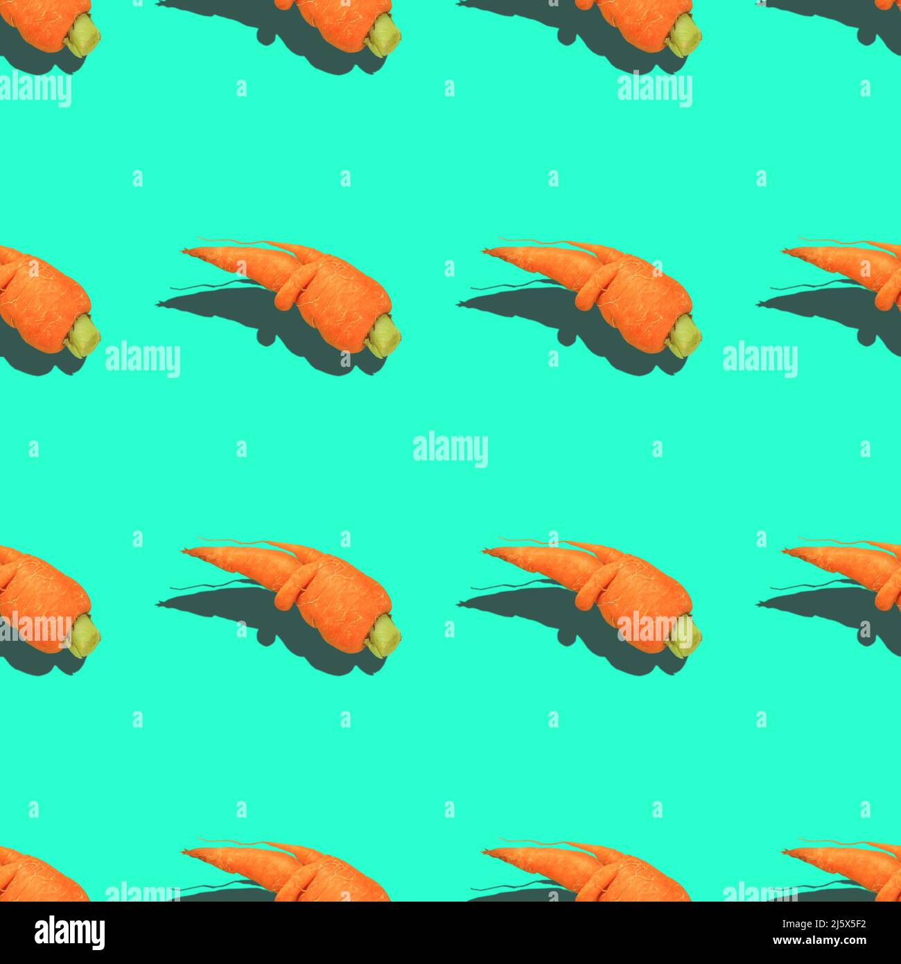 Ugly food. Deformed carrots on aqua turquoise background. Seamless ...