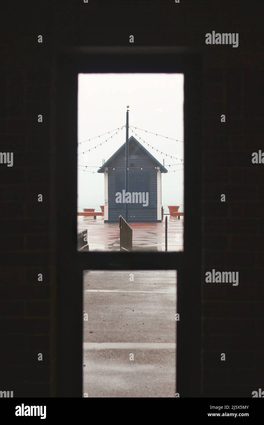A simple and plain wooden shack standing on the waterfront pier during ...