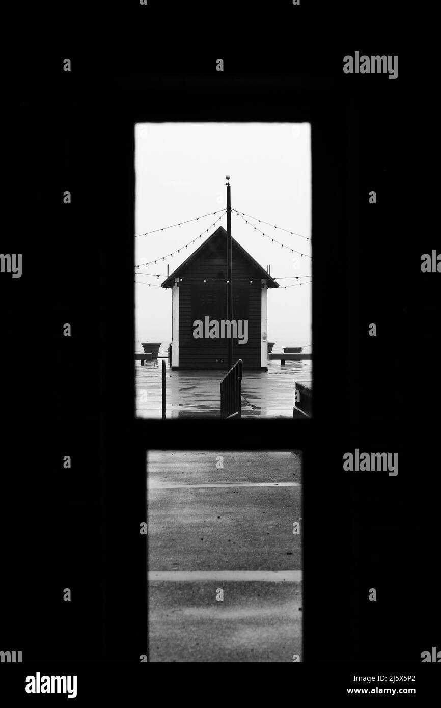 A simple and plain wooden shack standing on the waterfront pier during ...