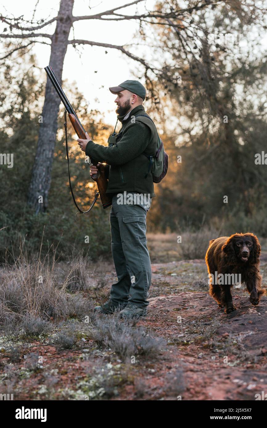 Hunter holding his shotgun up facing forward Stock Photo - Alamy