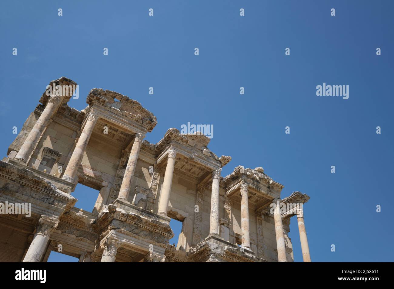 Blue sky and empty space dominates the columned facade of the Library ...
