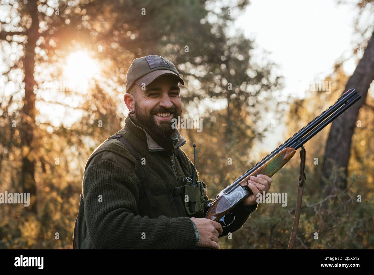 Hunter holding his shotgun while smiling looking at camera Stock Photo ...