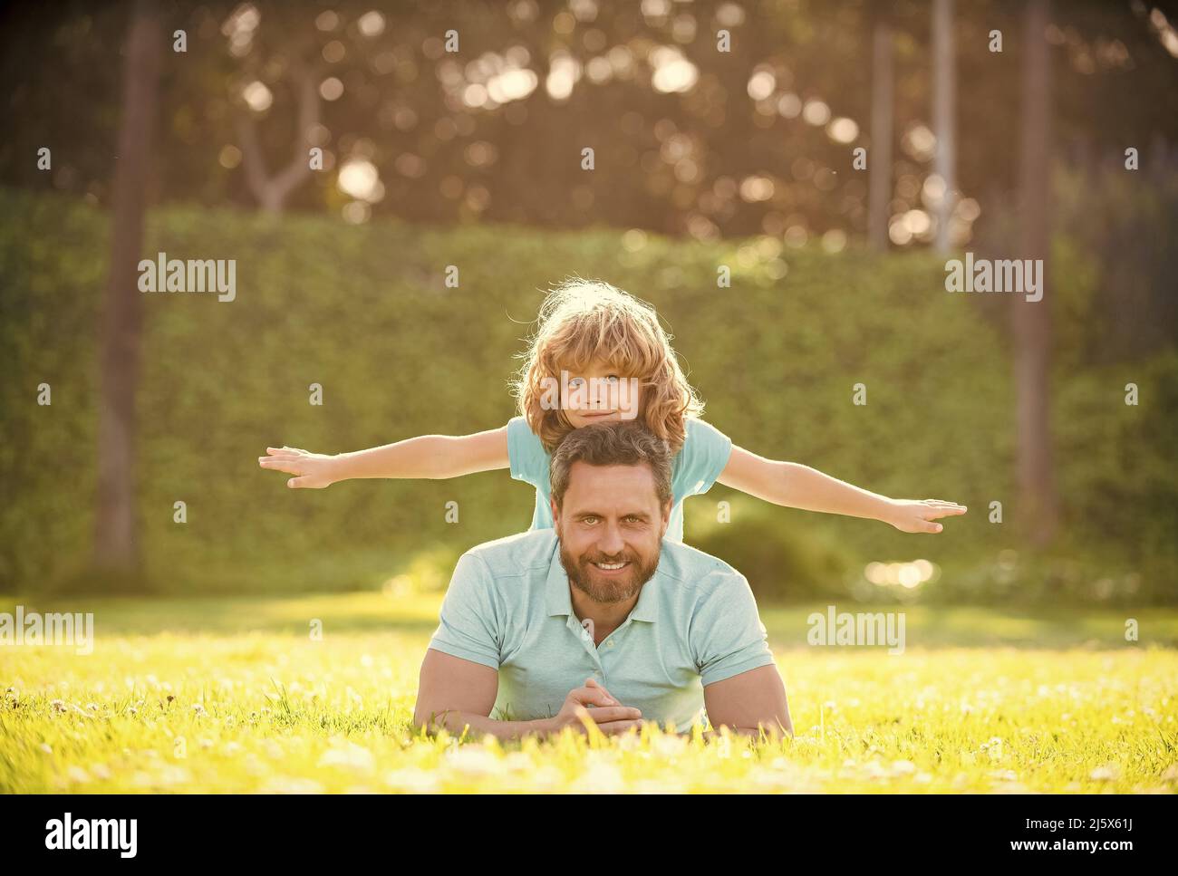 fathers day. cheerful father and son having fun in park. family value ...