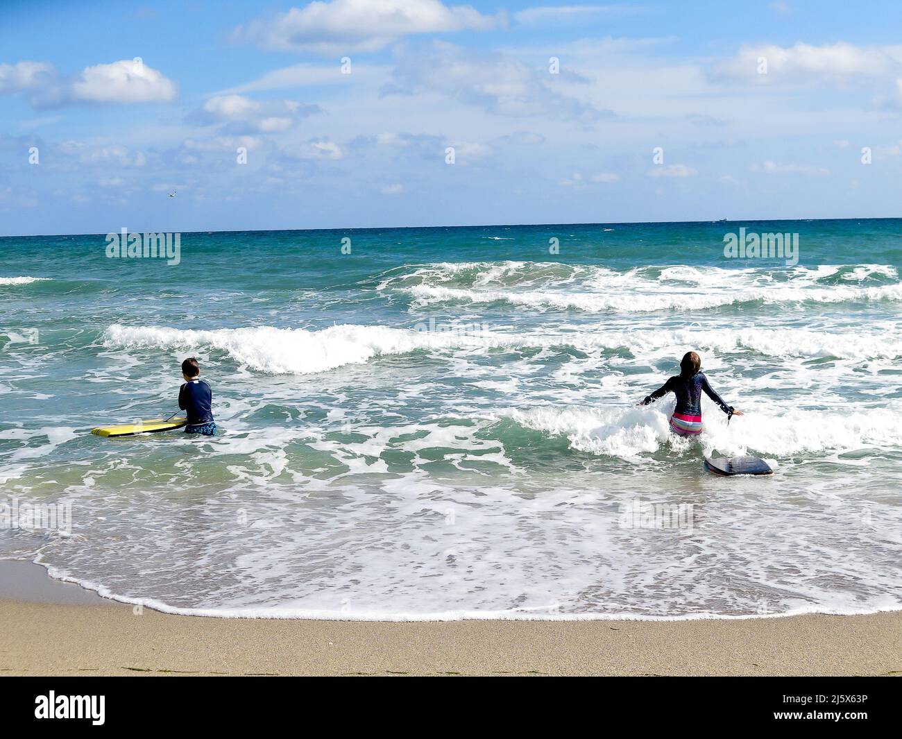 Kids playing in the surf with boogie boards at west Palm Beach, Florida ...
