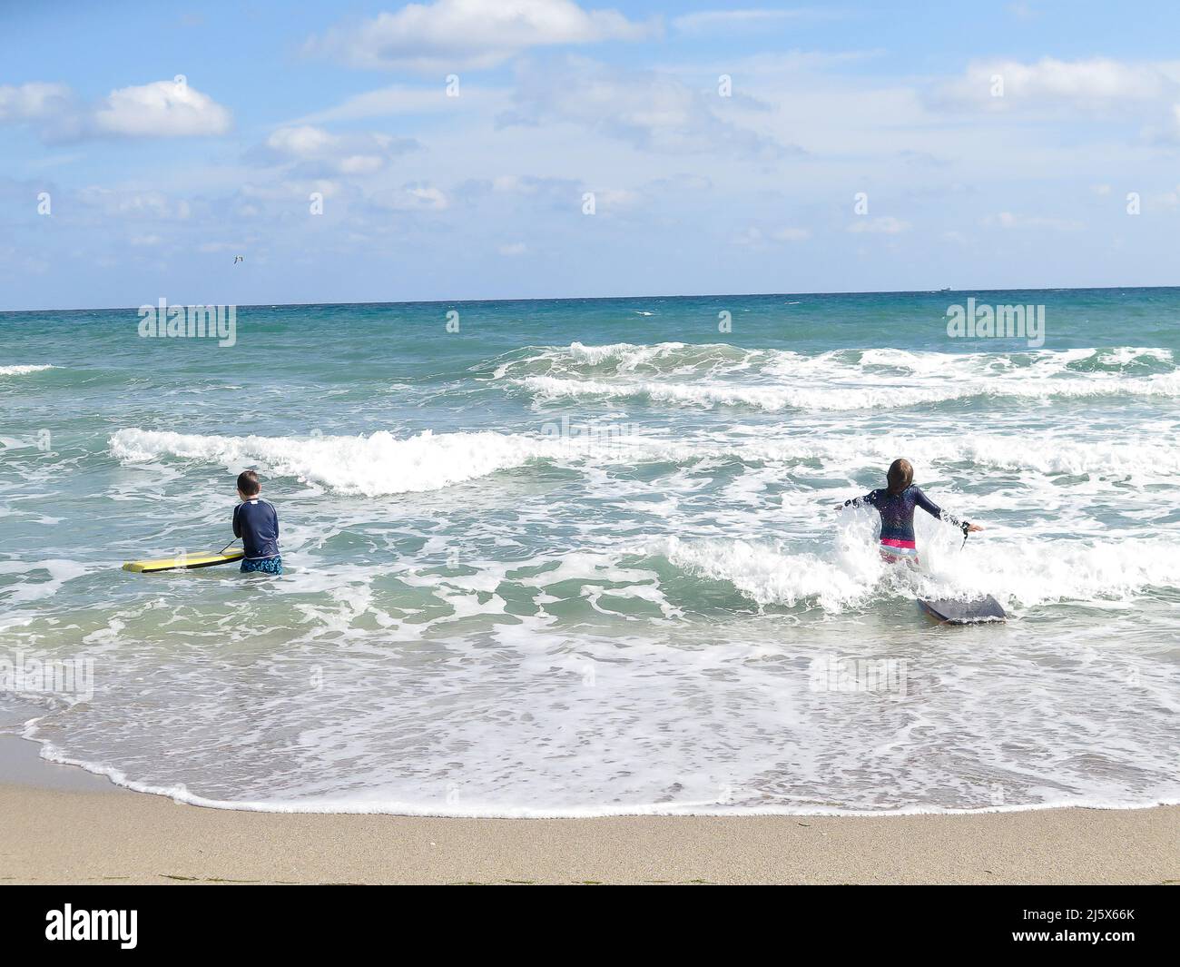 Kids playing in the surf with boogie boards at west Palm Beach, Florida ...