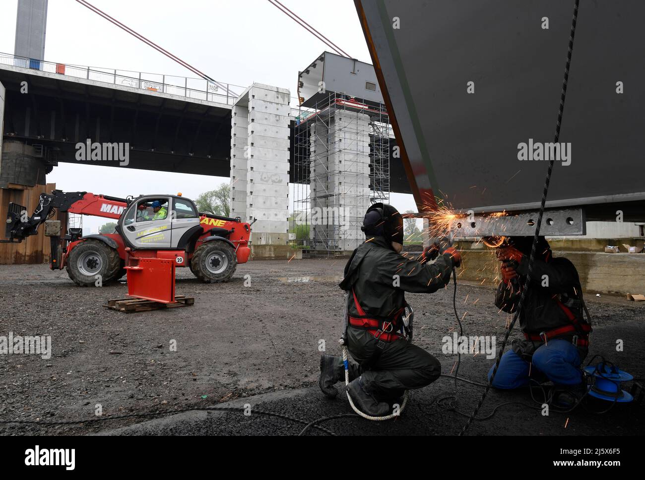 Merkenich, Germany. 26th Apr, 2022. Welders work on a steel bridge ...