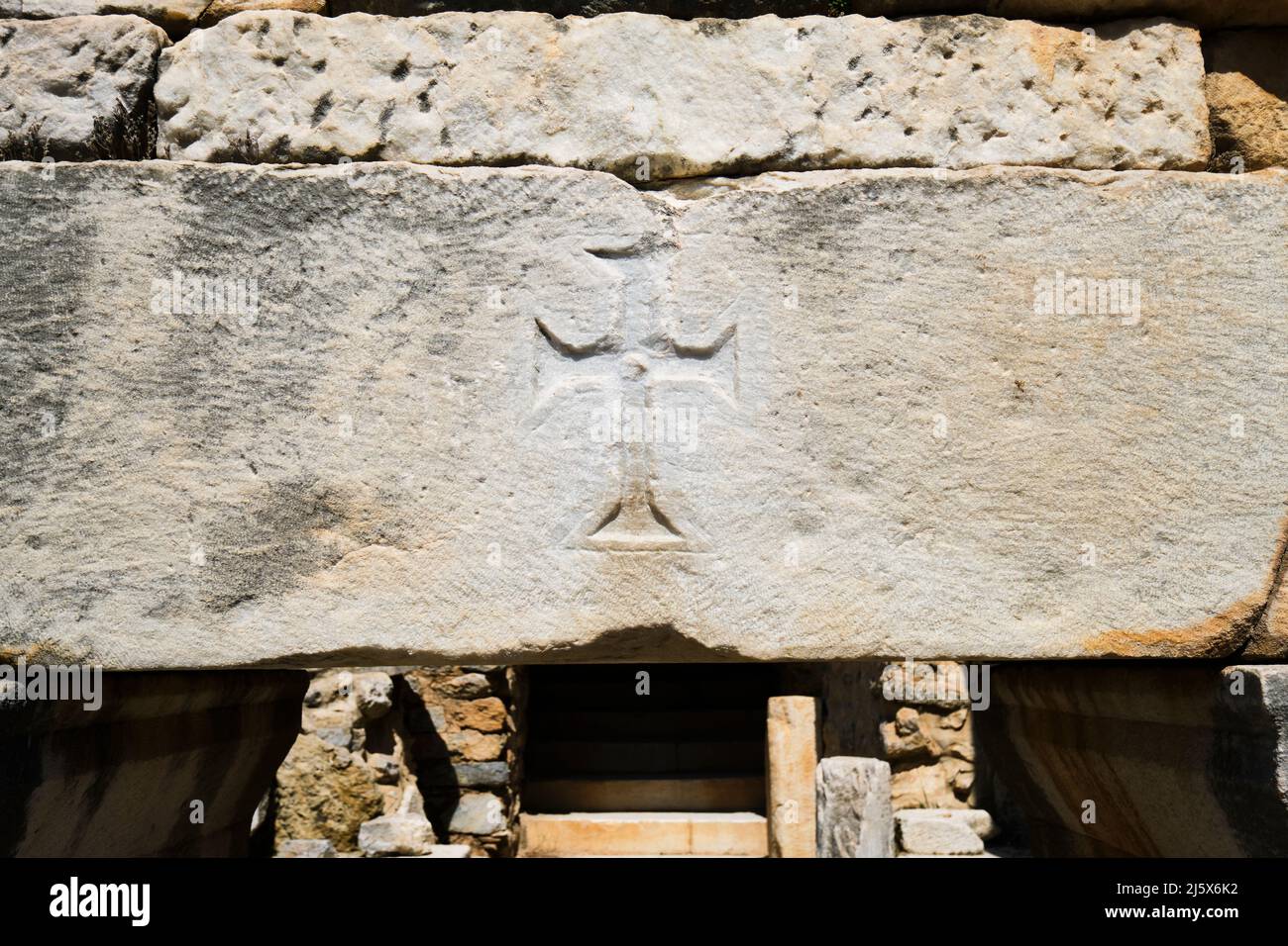 Detail, close up of a carved Christian cross in stone at the small ...