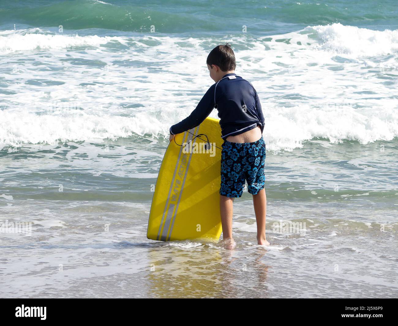 Kids playing in the surf with boogie boards at west Palm Beach, Florida ...