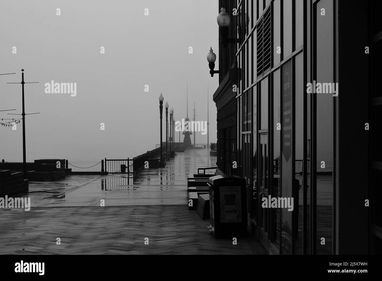 Waterfront pier in very heavy fog on the shoreline Stock Photo - Alamy