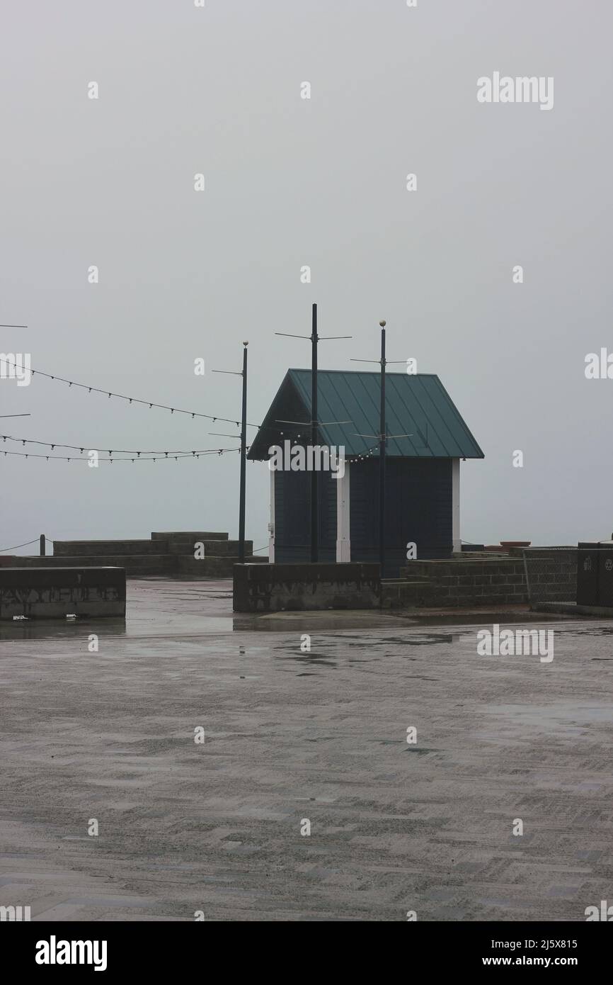 A simple and plain wooden shack standing on the waterfront pier during ...