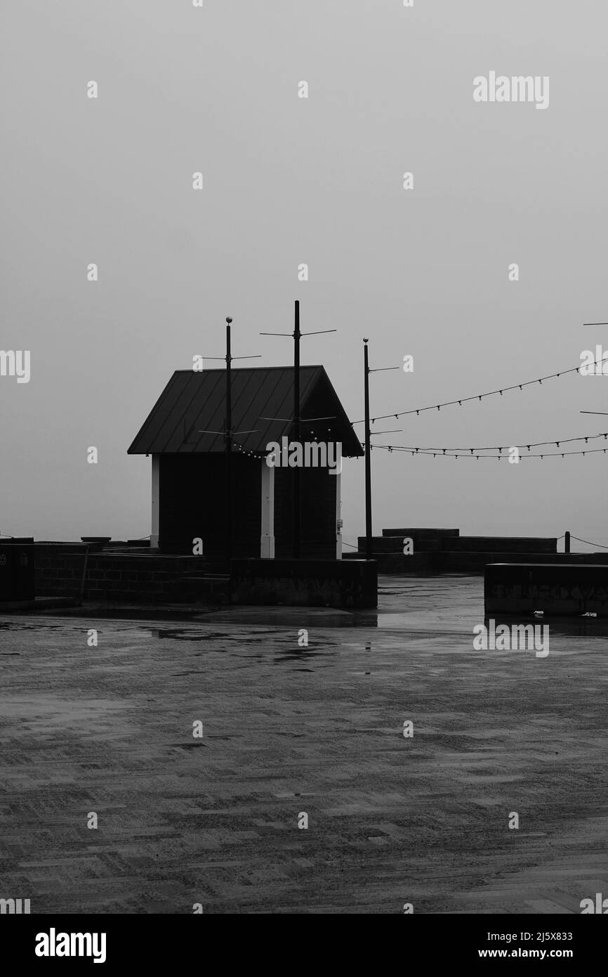 A simple and plain wooden shack standing on the waterfront pier during ...