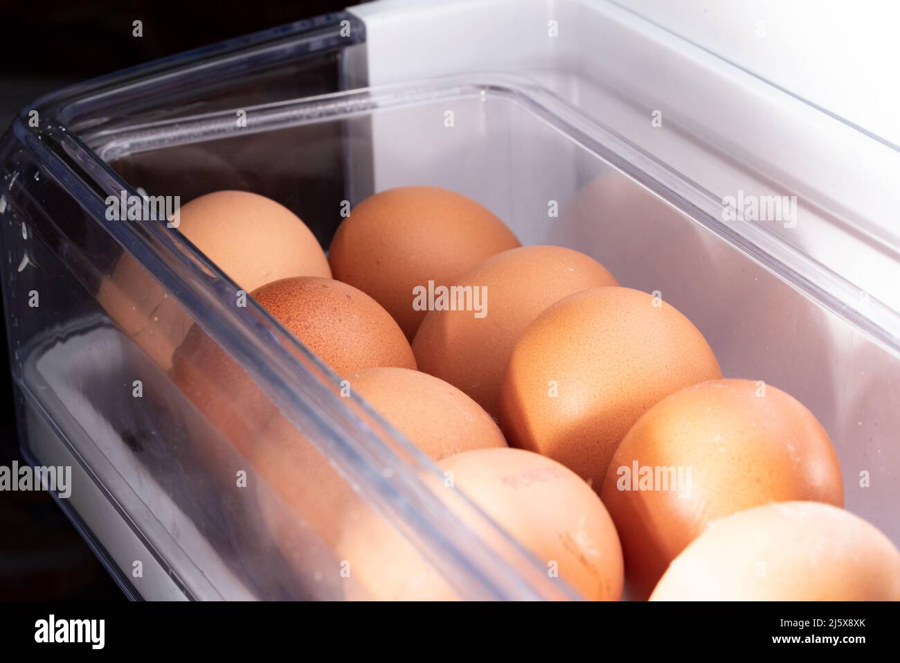 Eggs in the refrigerator arranged in rows. Low temperature storage of ...