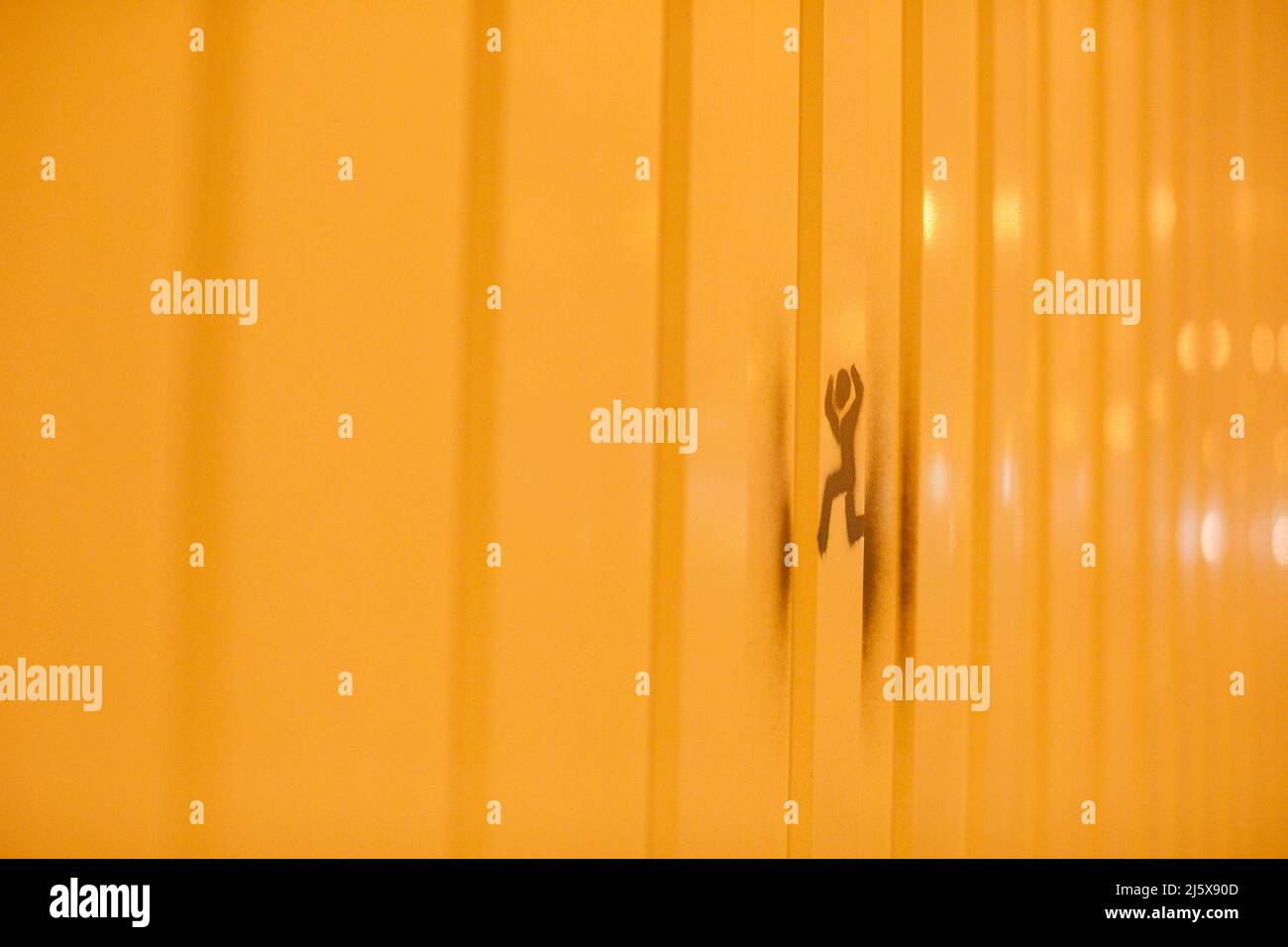 running figure on yellow background in the street Stock Photo - Alamy