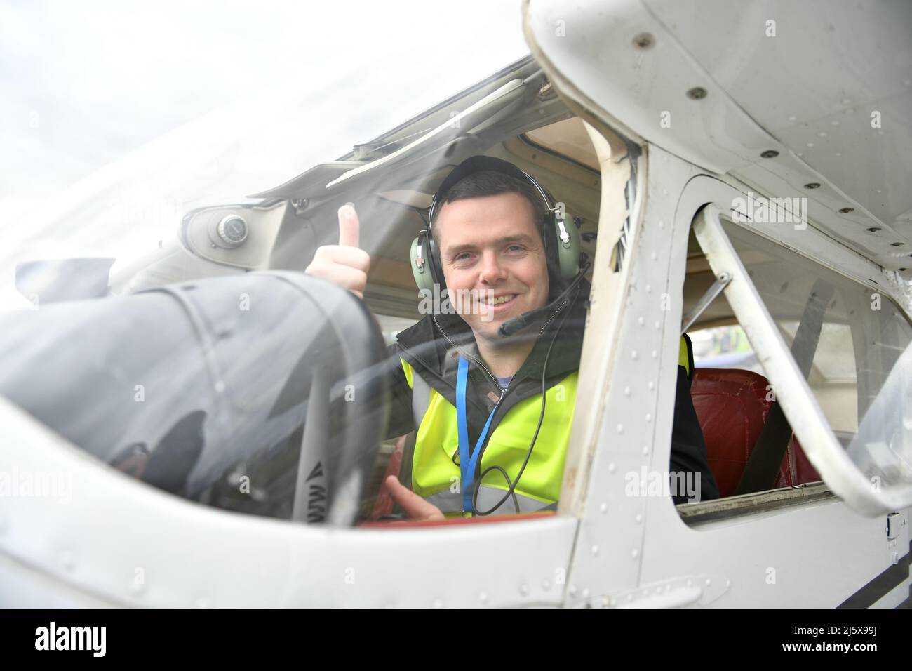 Zoom view douglas ross face thumbs up inside aircraft hi-res stock ...