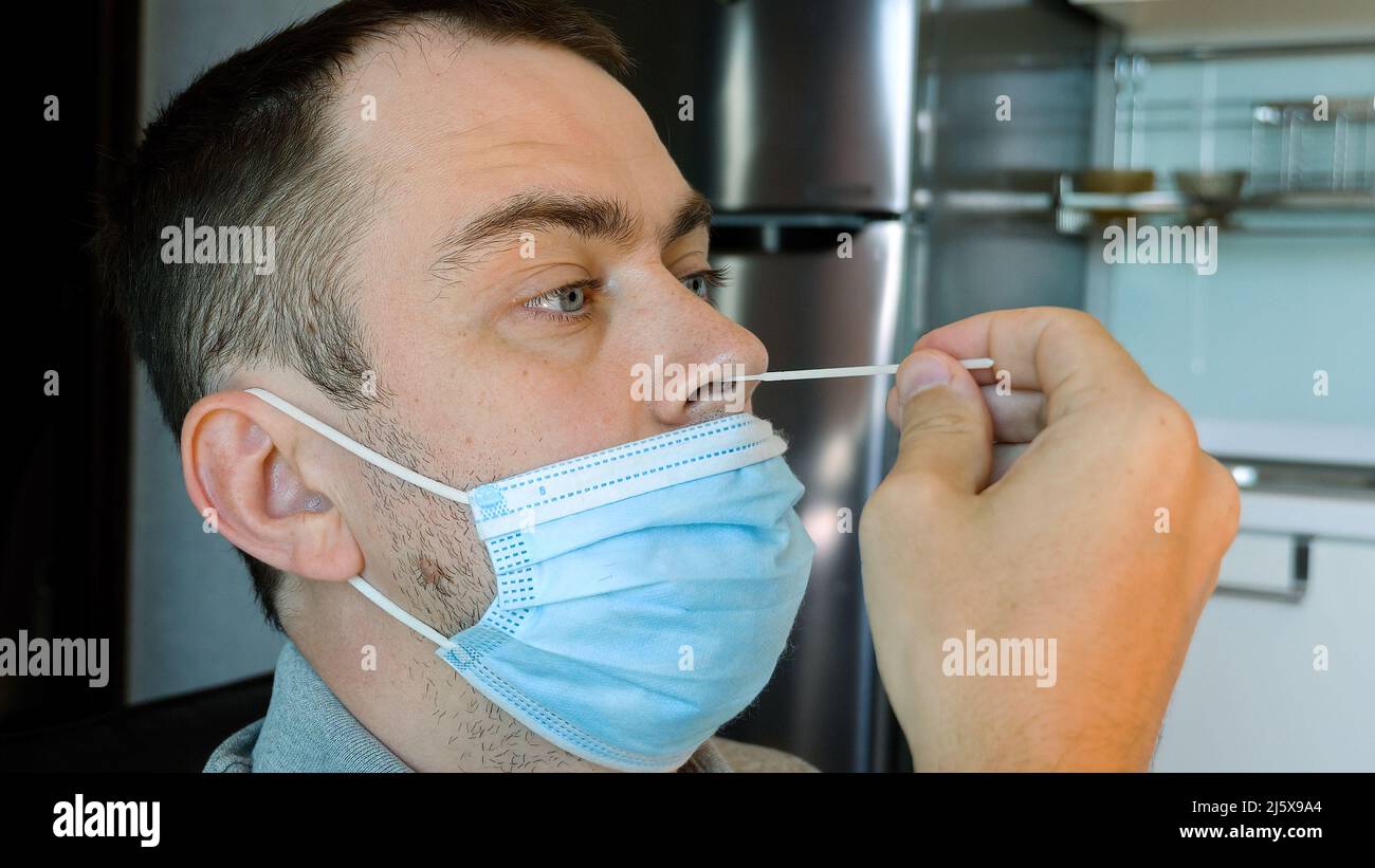 Man sitting at home, making self rapid test for COVID-19 with Antigen ...