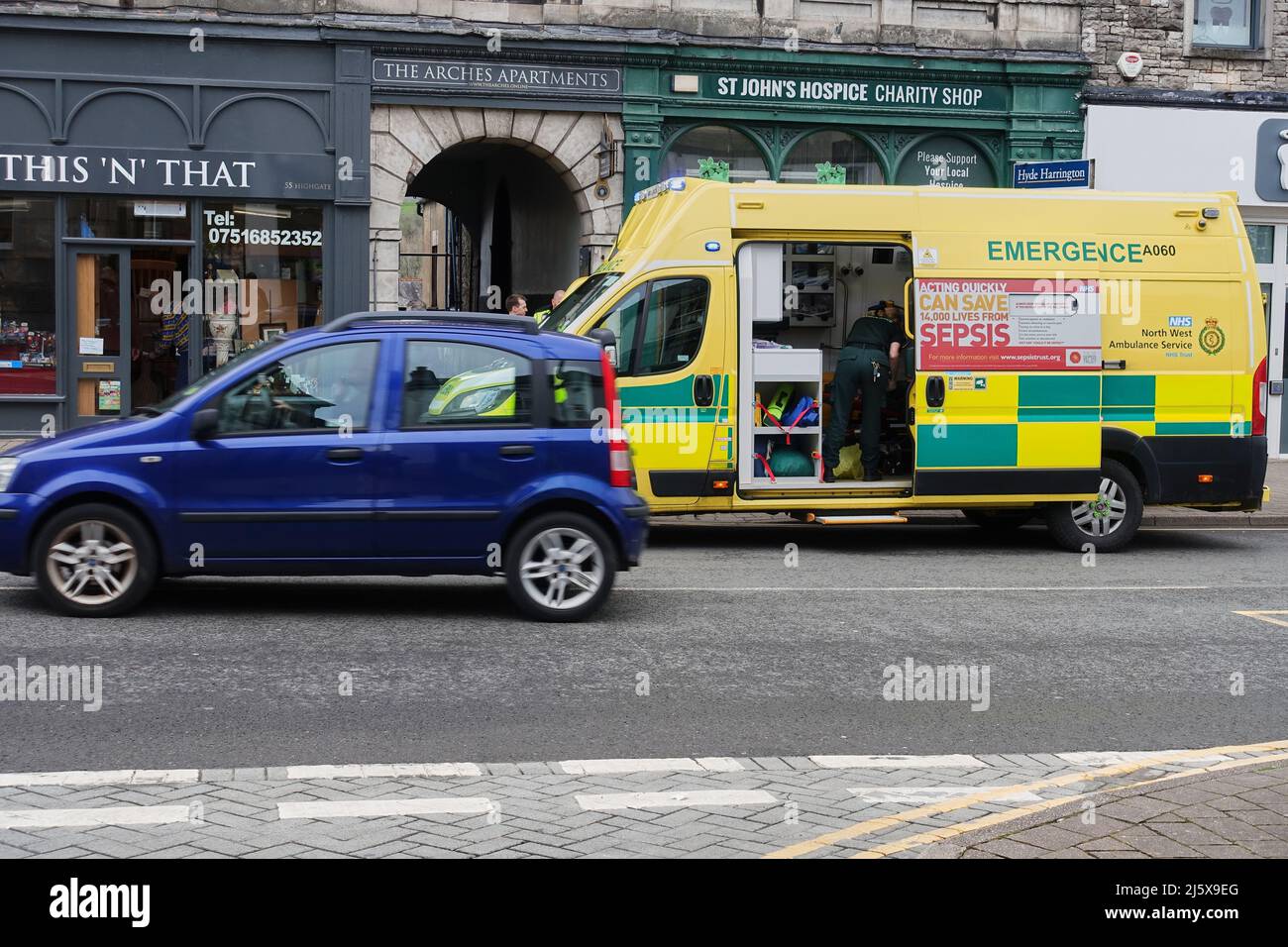 Emergency ambulance on call with its door open and paramedic inside ...